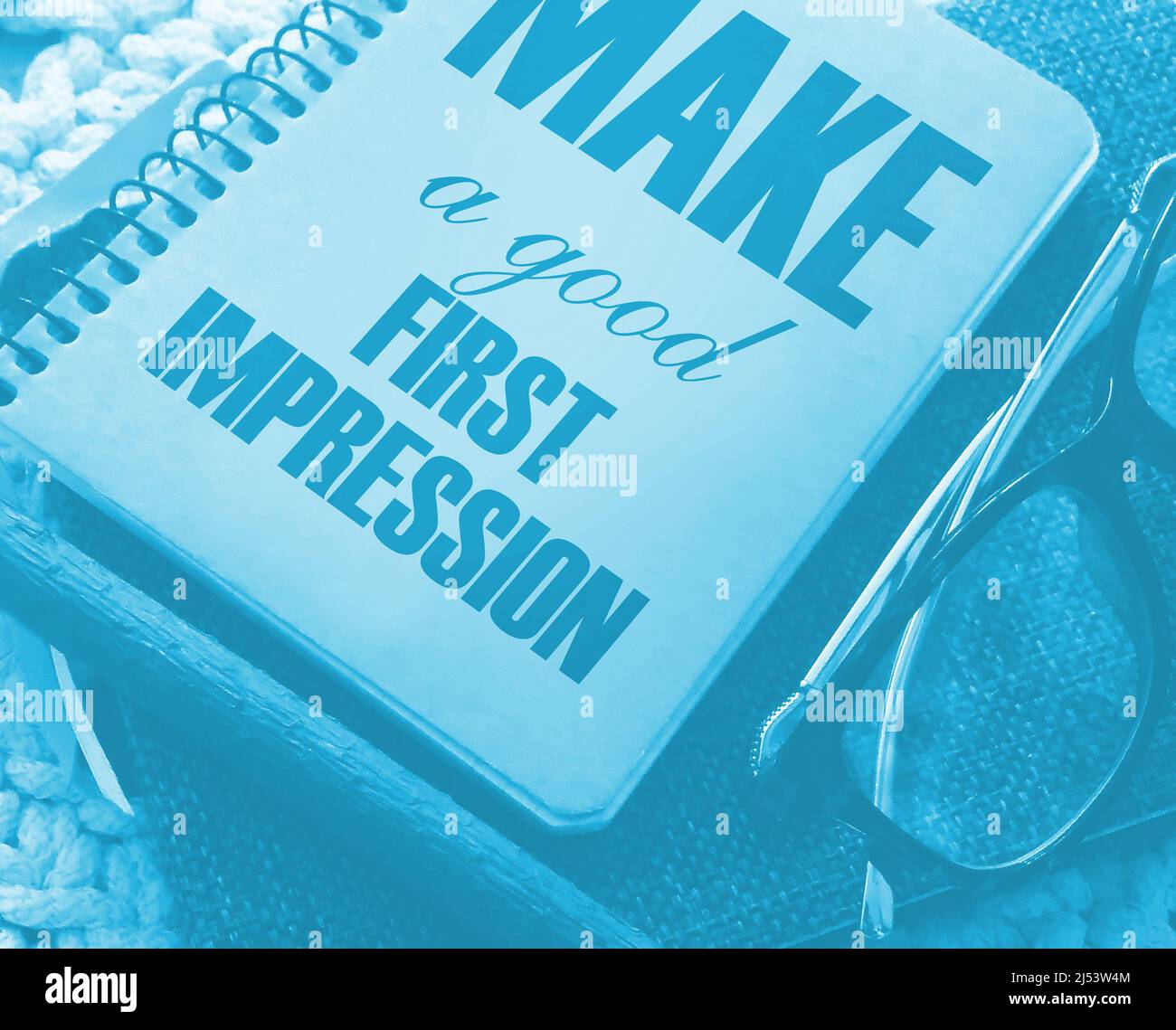 Make a Good First Impression written on book cover, eyeglasses and pen ...