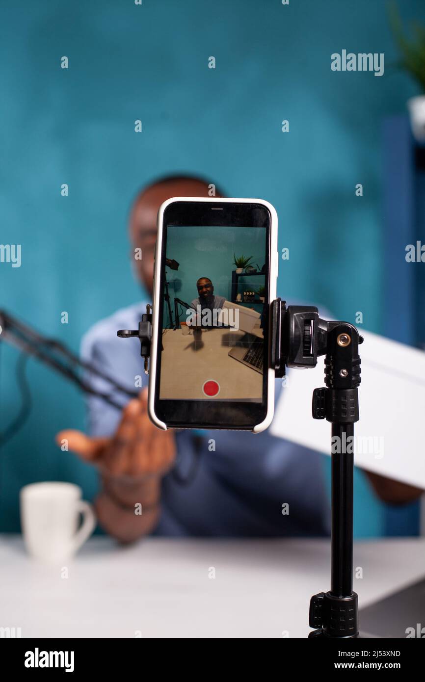 Selective focus on mobile phone recording influencer hosting online ...