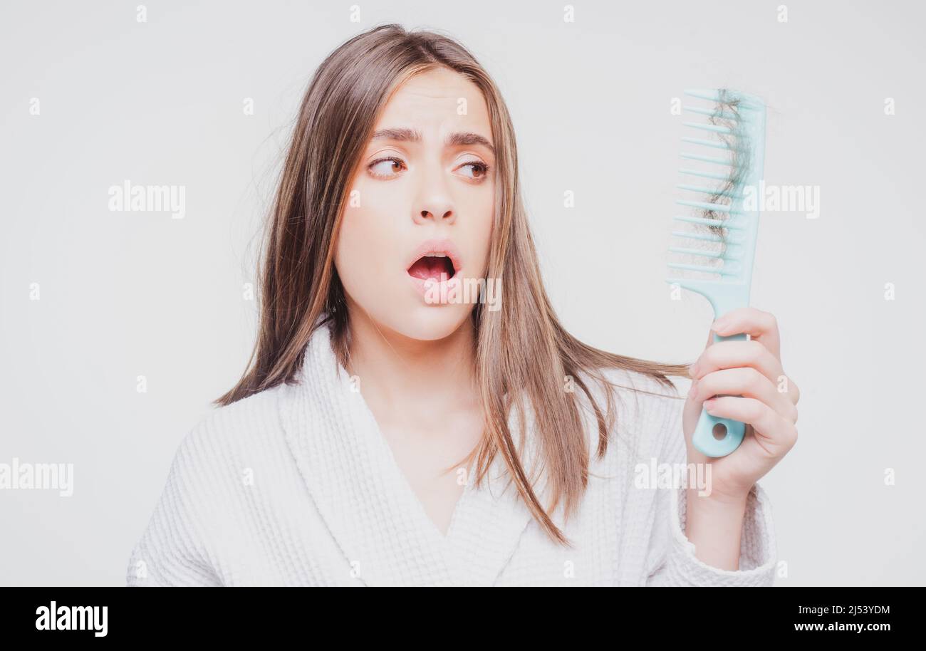 Woman with hair problem. Woman is looking shocked to her lost hair ...