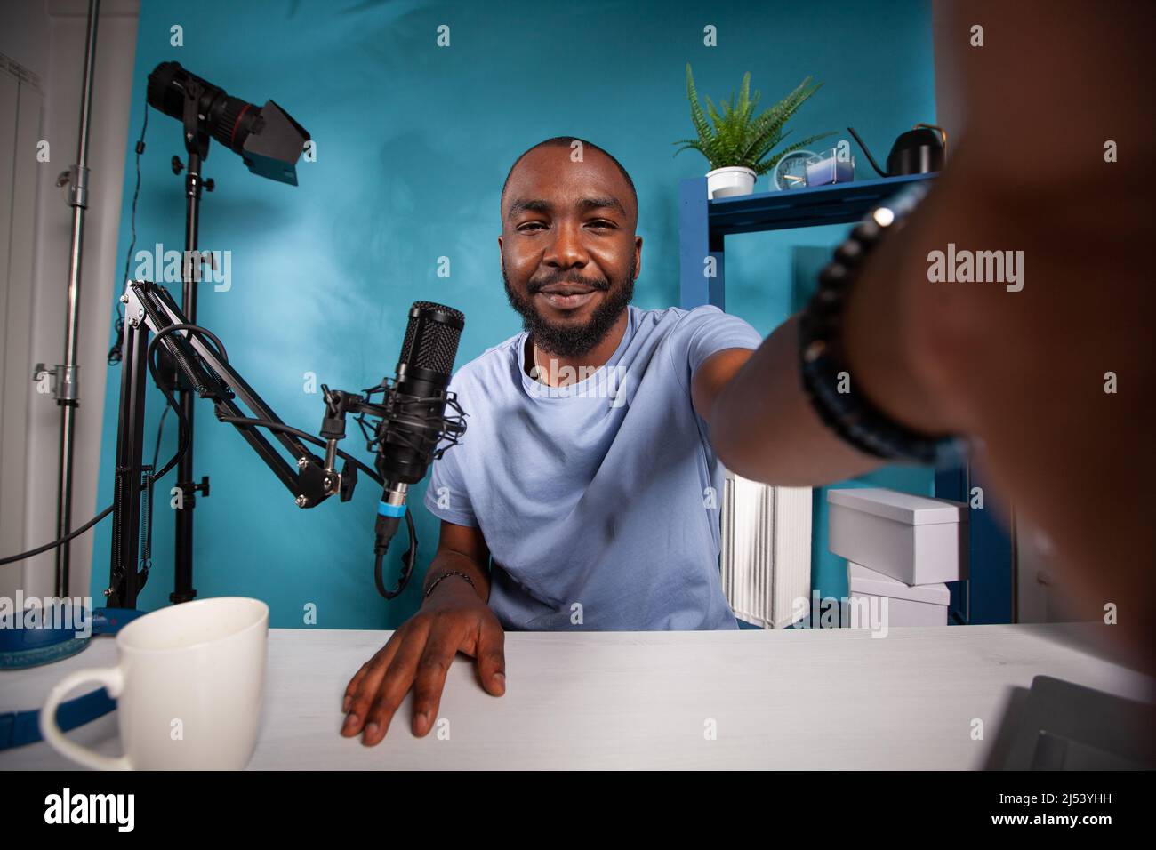 Wide angle view of famous vlogger taking a selfie in vlog studio ...