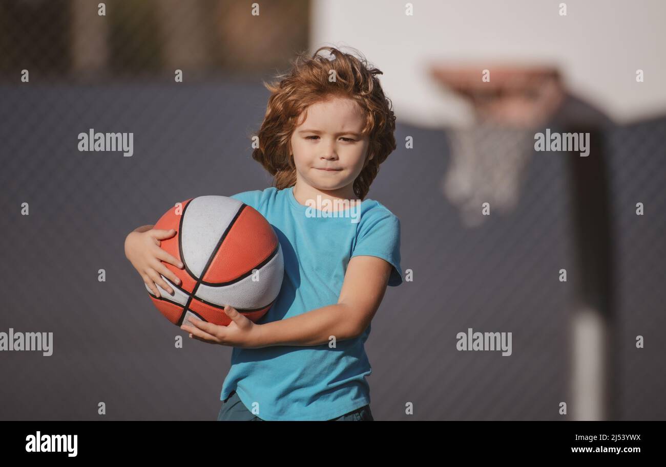 Kid playing basketball with basket ball. Kid posing with a basketball ...