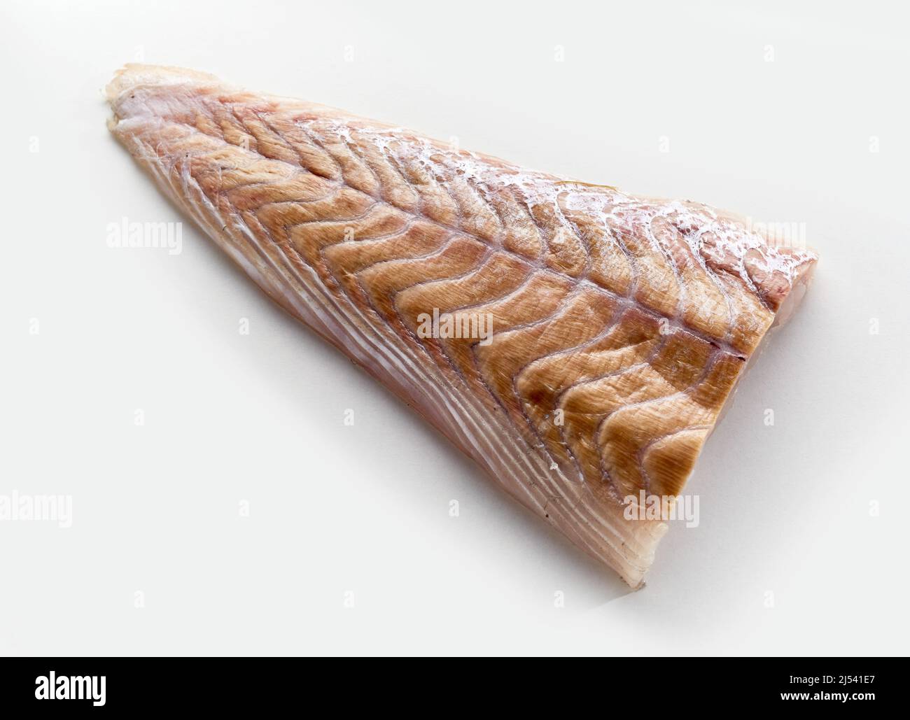 From above of piece of fresh raw fish fillet placed on white background ...