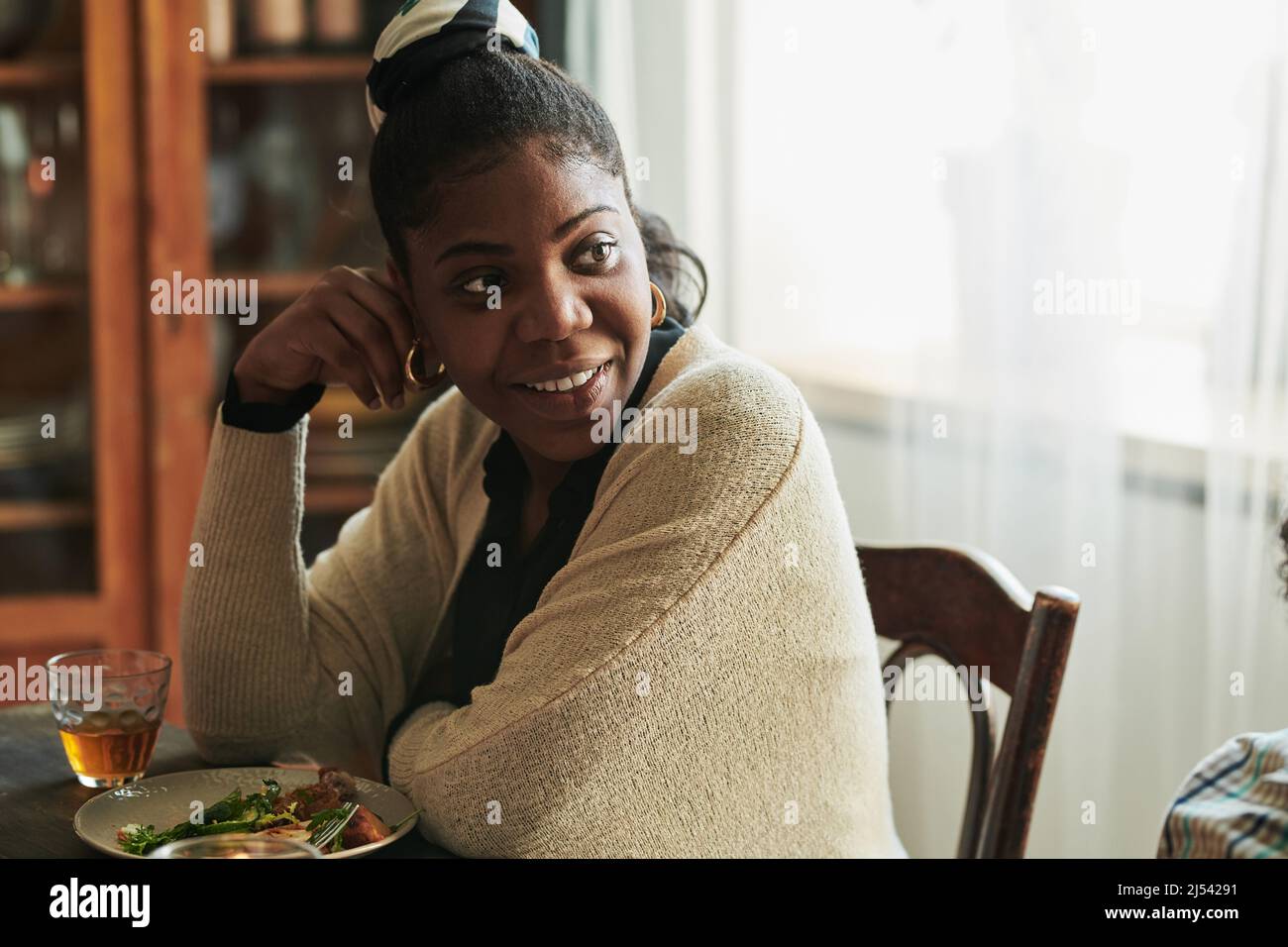 Young woman sitting dining table hi-res stock photography and images ...