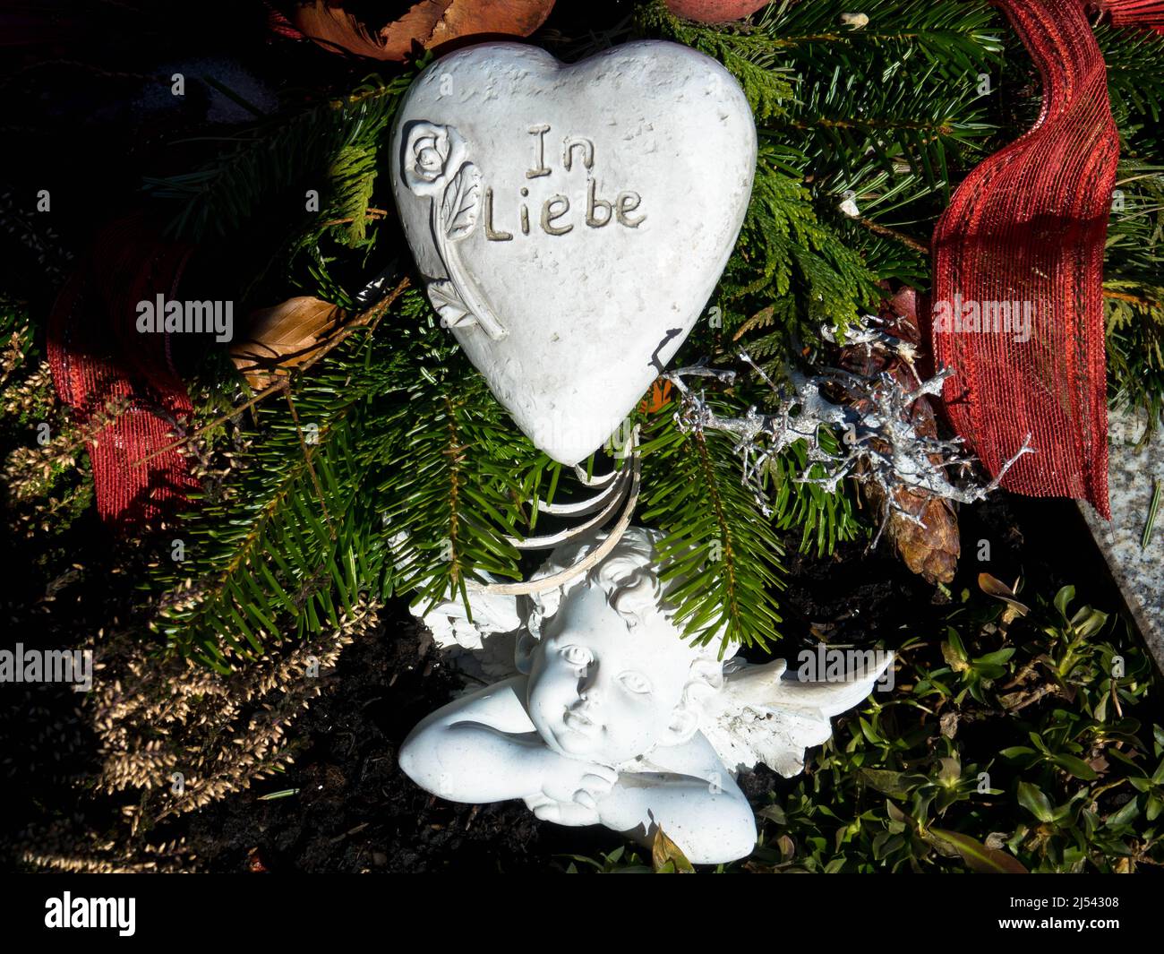 Angel sculpture with head looking thoughtfully into the distance. Grave ...
