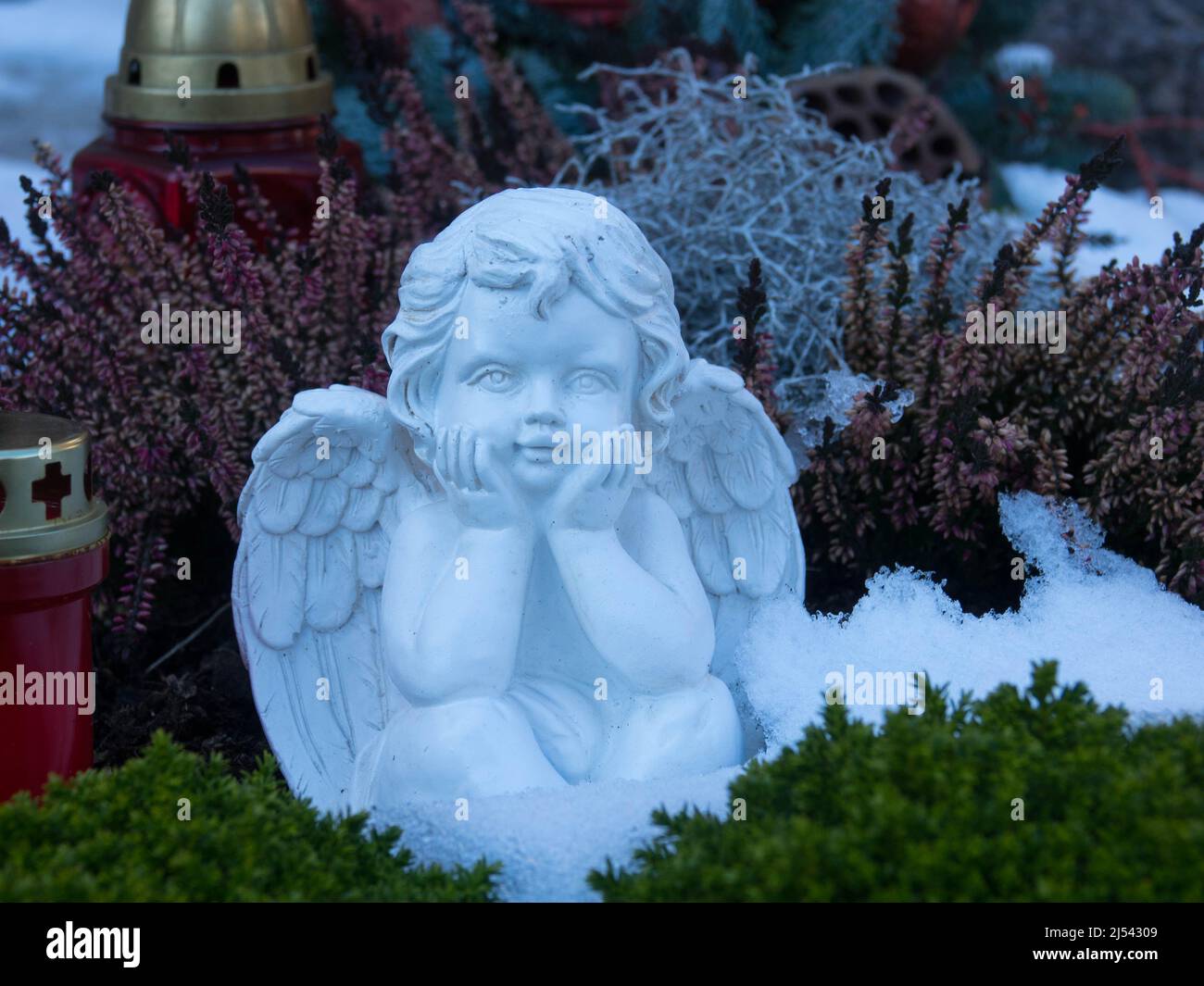Angel sculpture with head looking thoughtfully into the distance. Grave ...