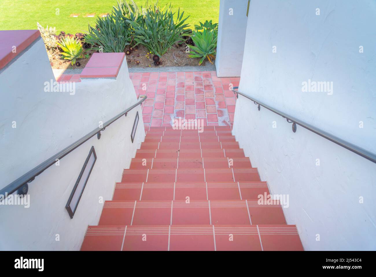Stairs with red tile steps heading to the red stone pavement downstairs ...