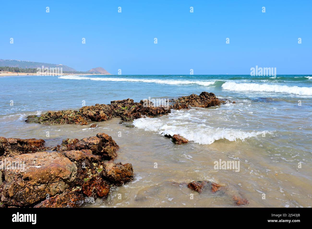 Vertical sea rock column overlooking the incoming waves Stock Photo - Alamy