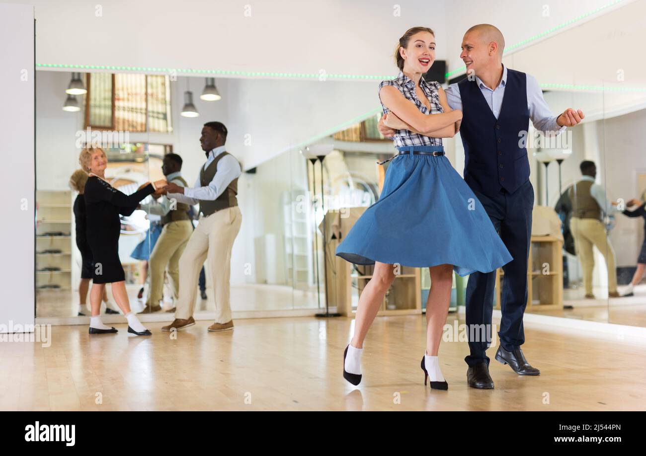 Adult dancing couple enjoying active swing Stock Photo - Alamy