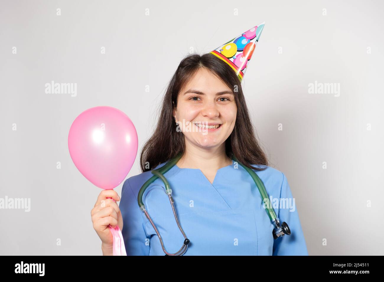 The doctor holds a festive balloon and smiles, happy doctor's day Stock ...