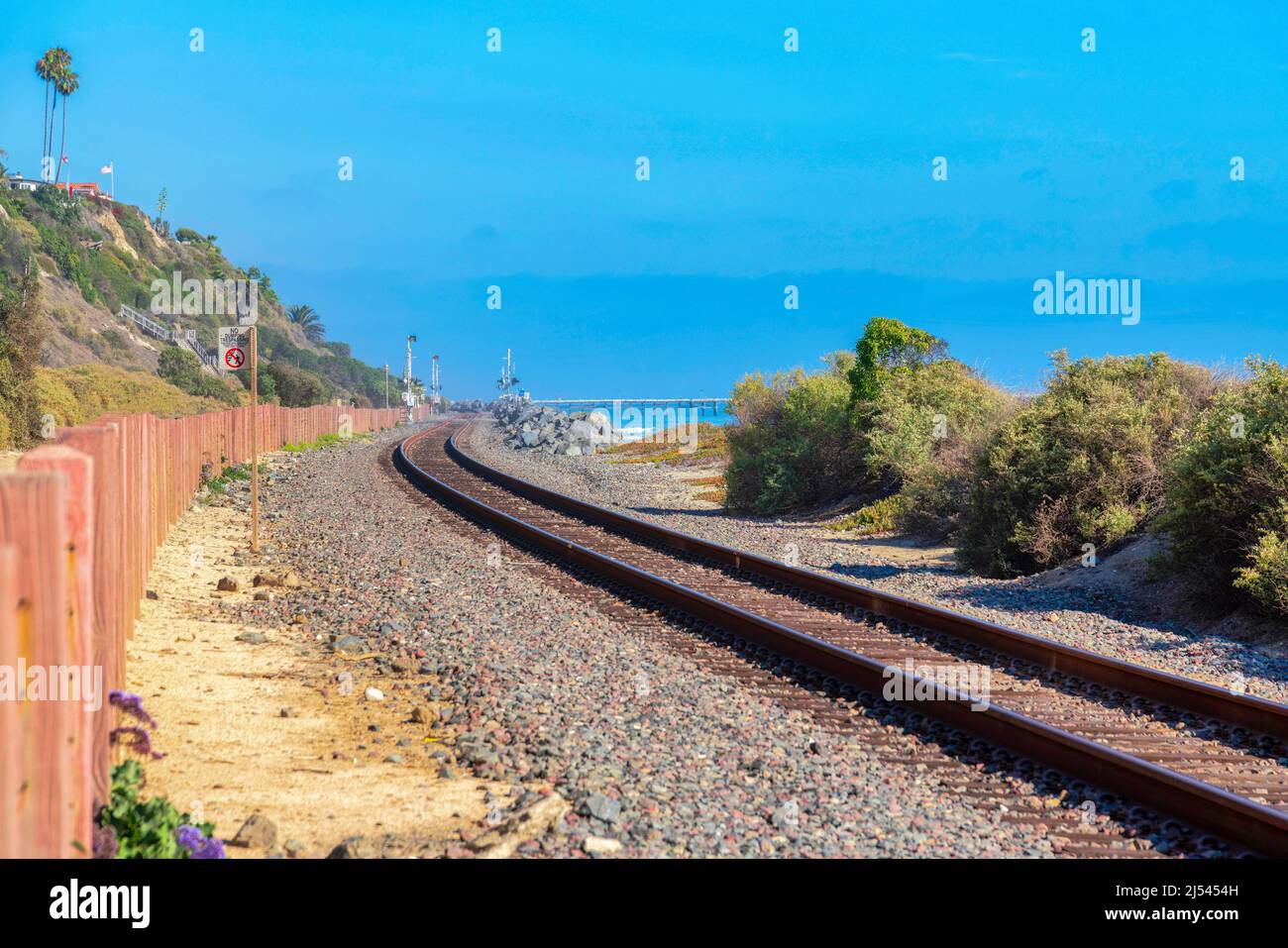 Train track in San Clemente, California with wooden posts barrier on ...