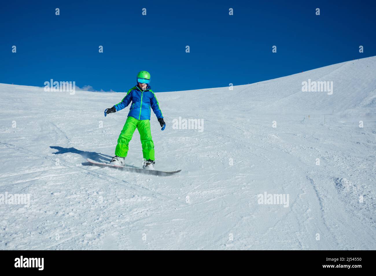 Front view action photo of boy snowboard down mountain slope Stock ...