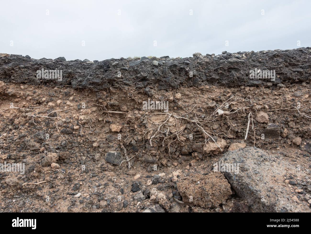 Exposed layers on old tarmac road. Erosion, climate change Stock Photo ...