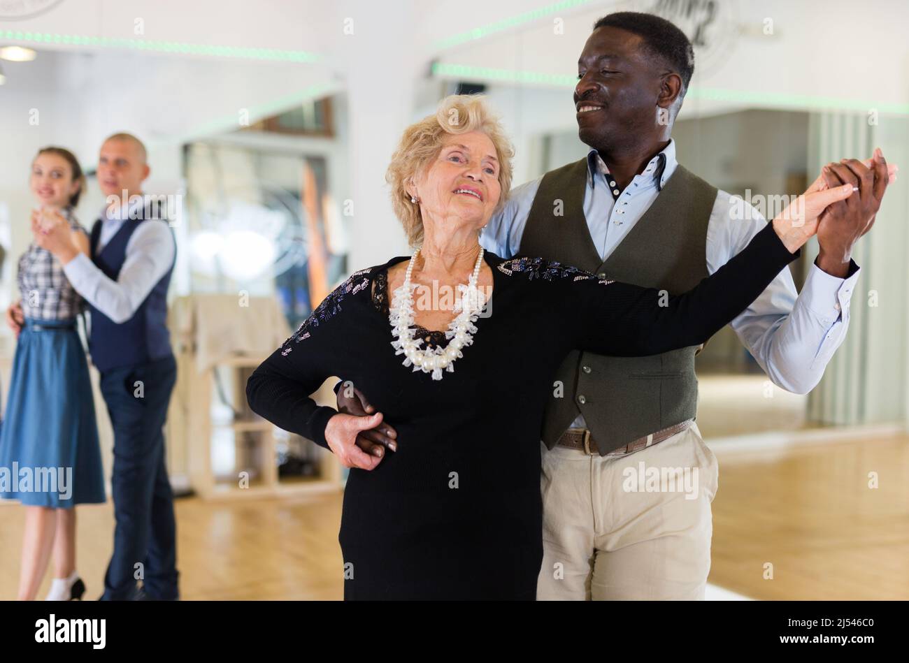 Man and mature woman learning to dance classical ballroom dance Stock ...