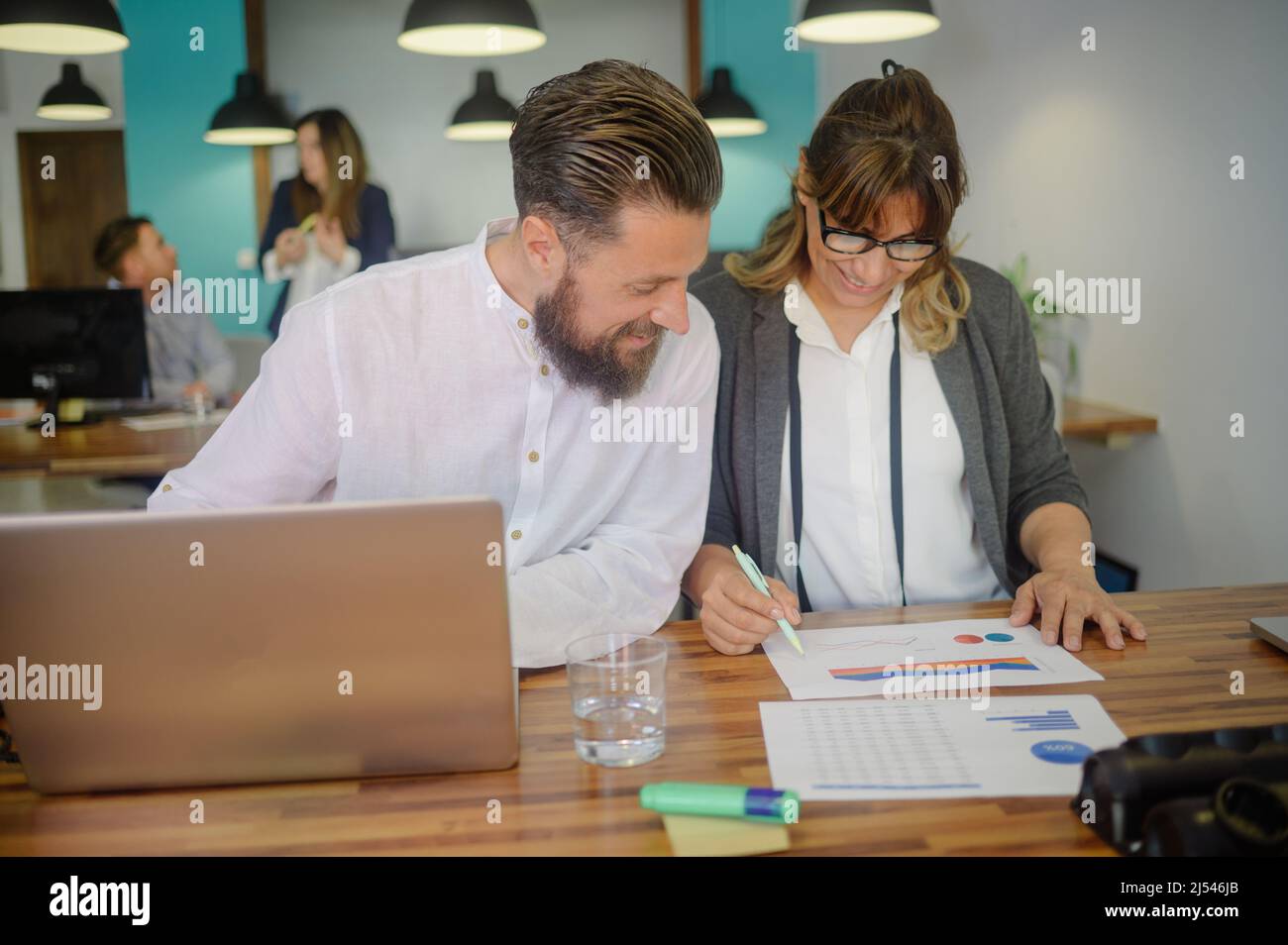 Focused colleagues working on project in coworking Stock Photo - Alamy