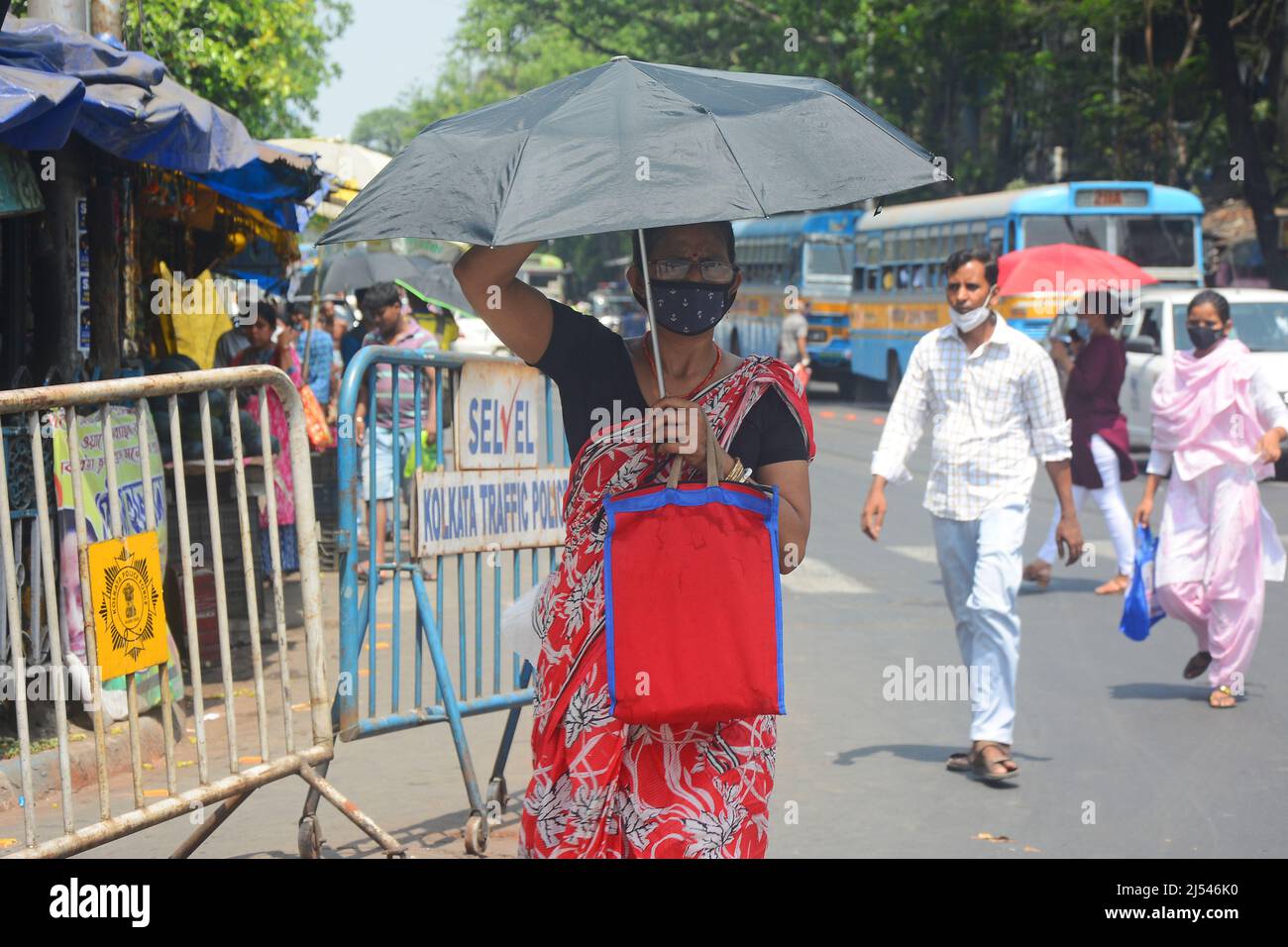 Kolkata, West Bengal, India. 18th Apr, 2022. A woman came outside ...