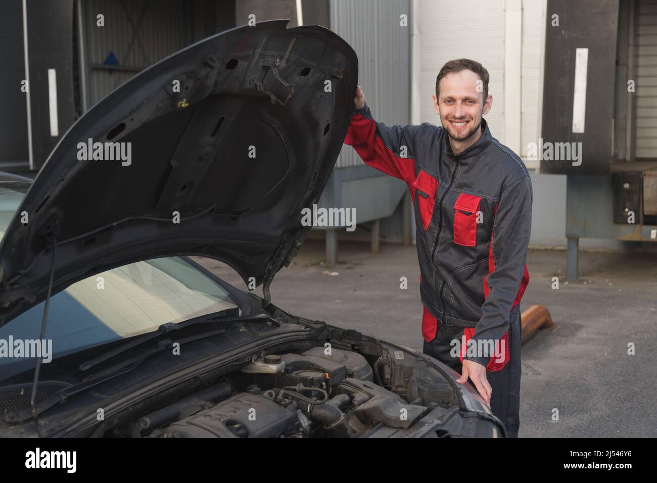 Auto mechanic expert stands at car with opened hood. Used car ...