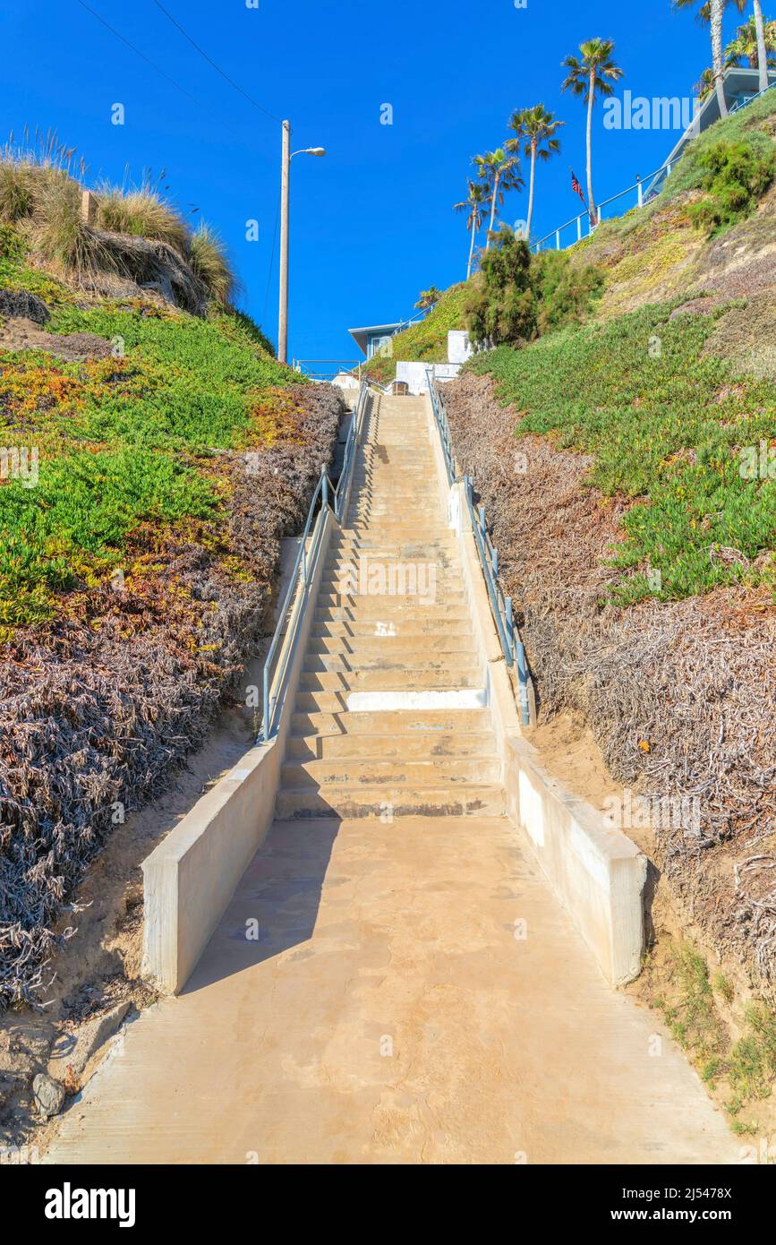 Outdoor concrete staircase on a slope with shrubs at San Clemente ...