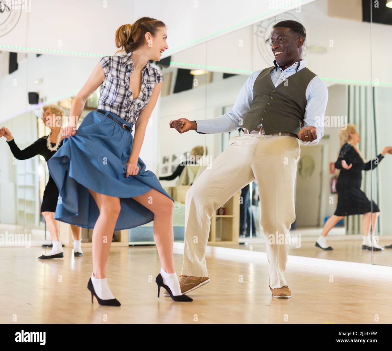 Woman with african man practising charleston dancing Stock Photo - Alamy