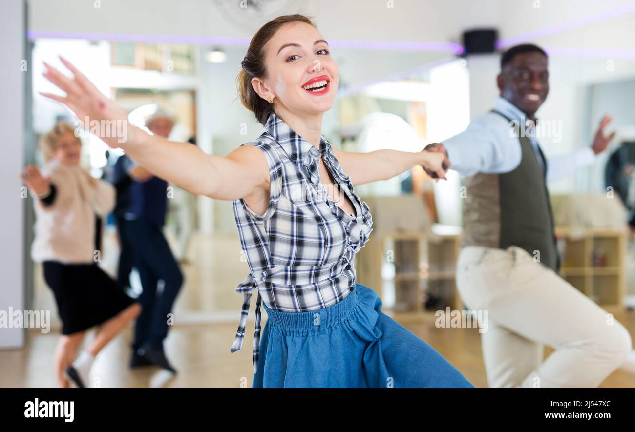 Cheerful female practicing lindy hop in pair with man Stock Photo - Alamy