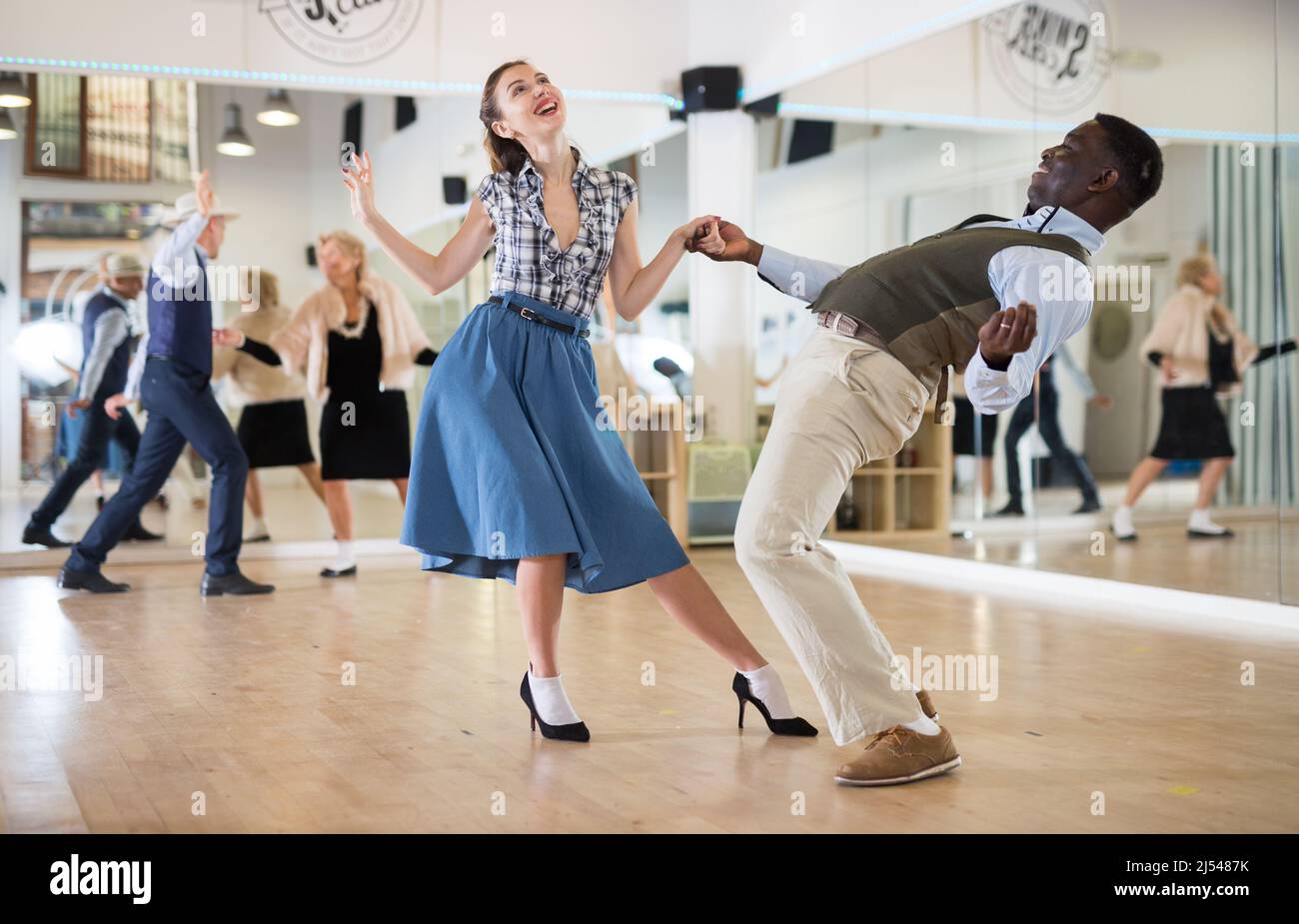 Woman with african man practising charleston dancing Stock Photo - Alamy