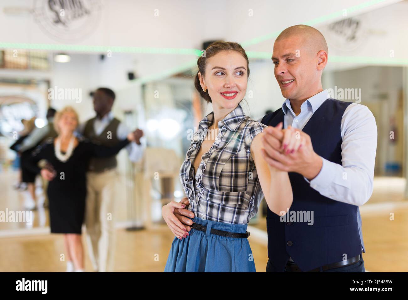 Man and woman performing ballroom dance in dancing room Stock Photo - Alamy