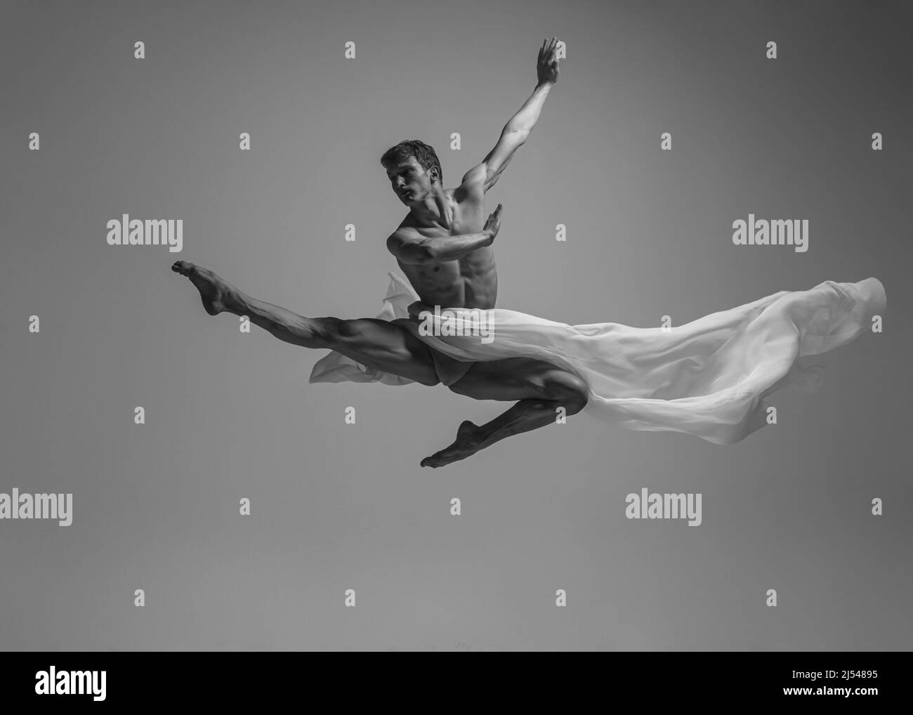 Black and white portrait of graceful muscled male ballet dancer dancing ...