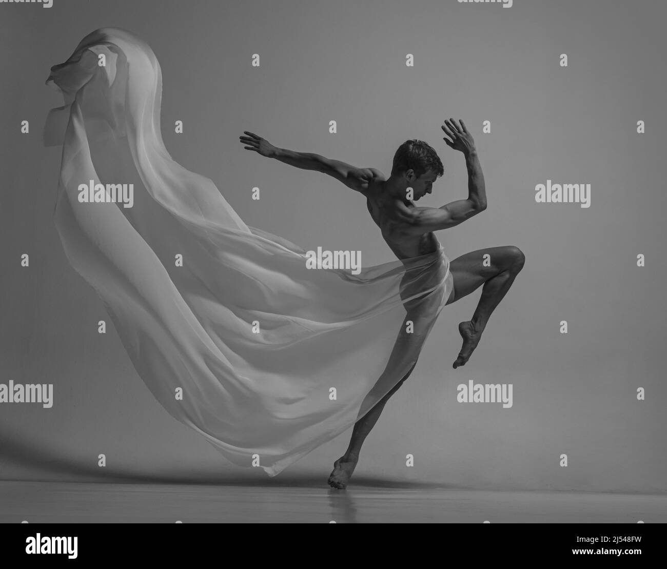 Black and white portrait of graceful muscled male ballet dancer dancing ...