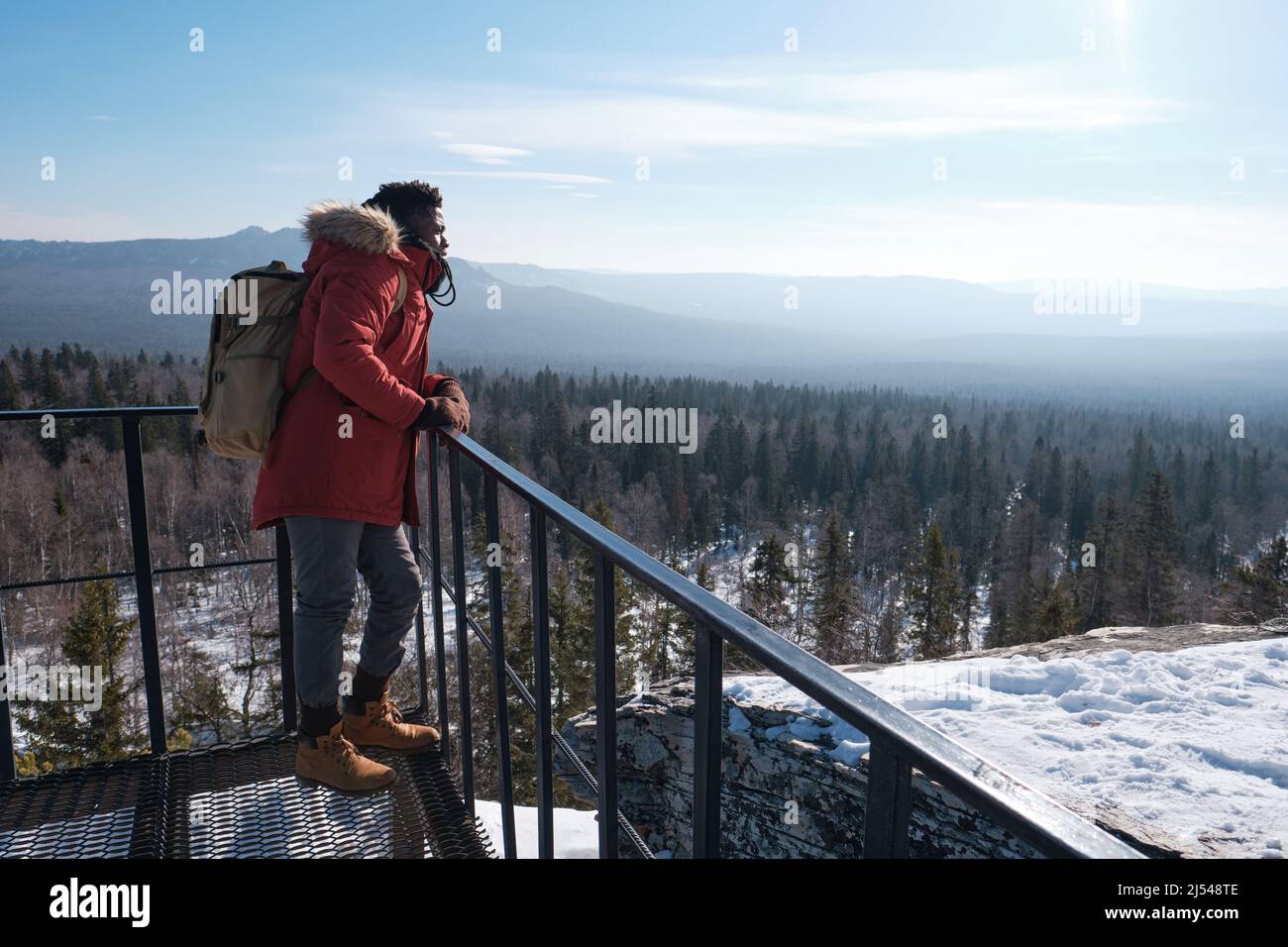 Young African American man wearing backpack standing relaxed at ...