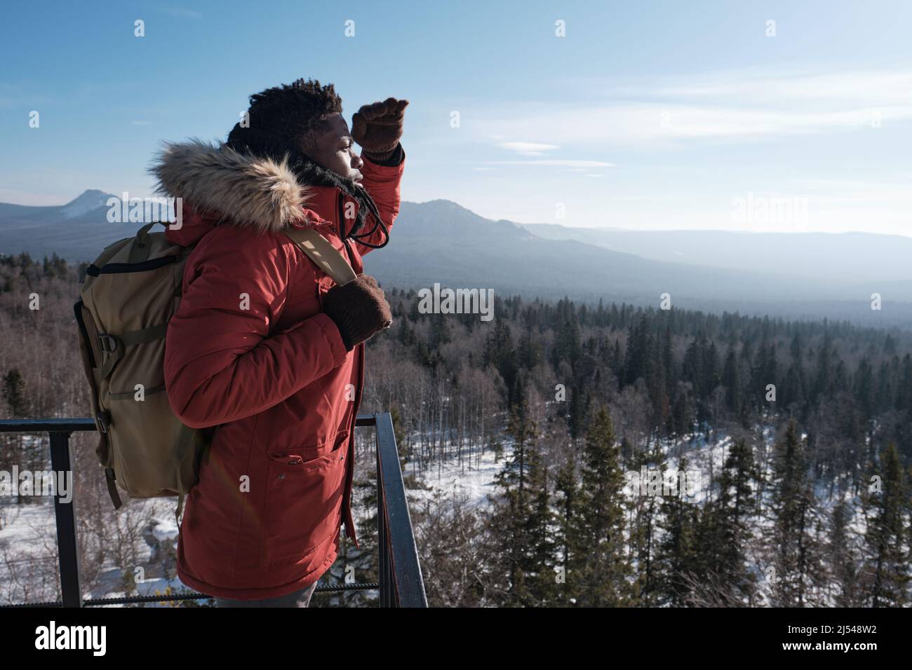 Young African American traveler wearing backpack standing at ...