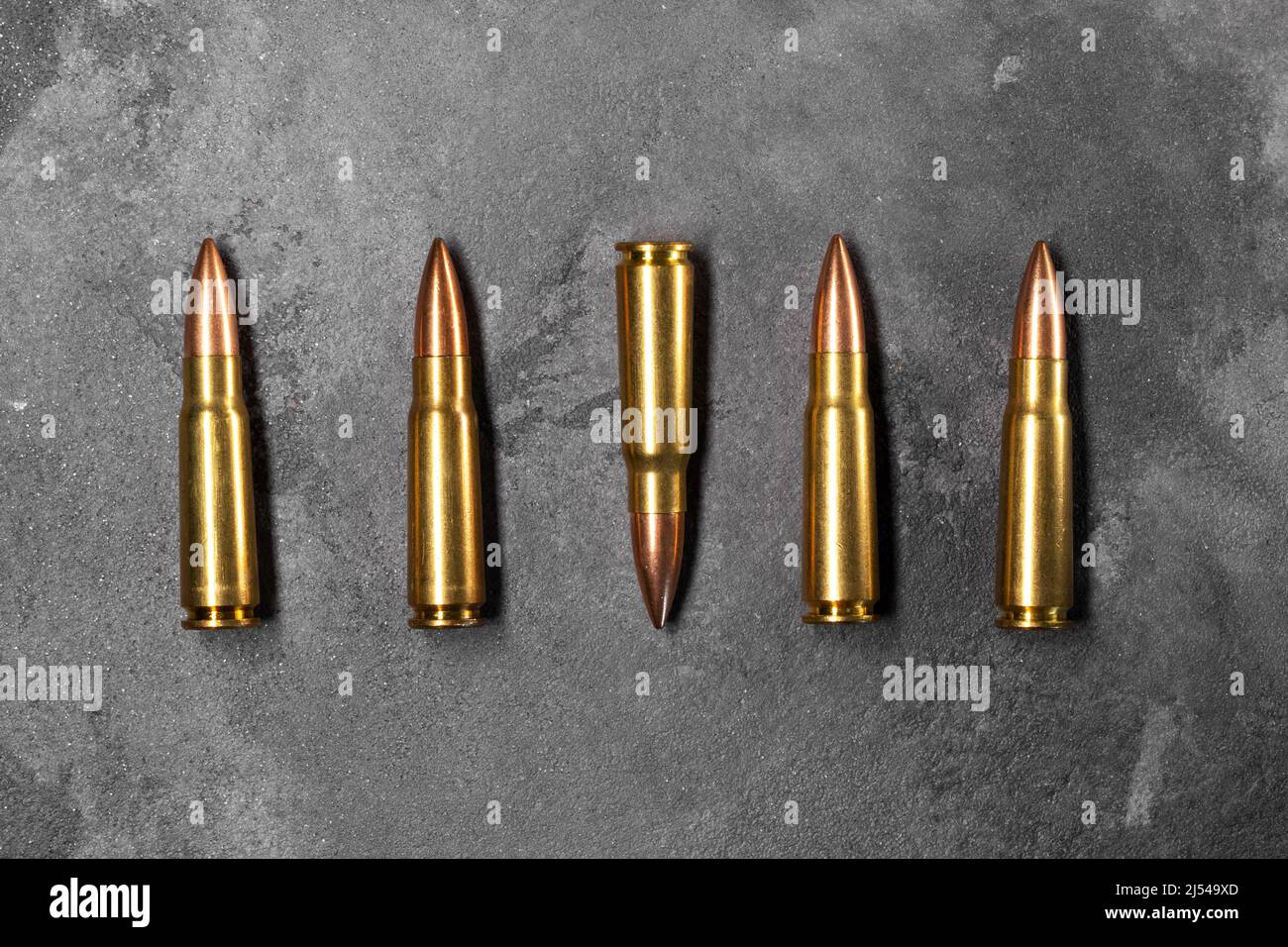 Bullets on gray background. One bullet positioned in opposite direction ...