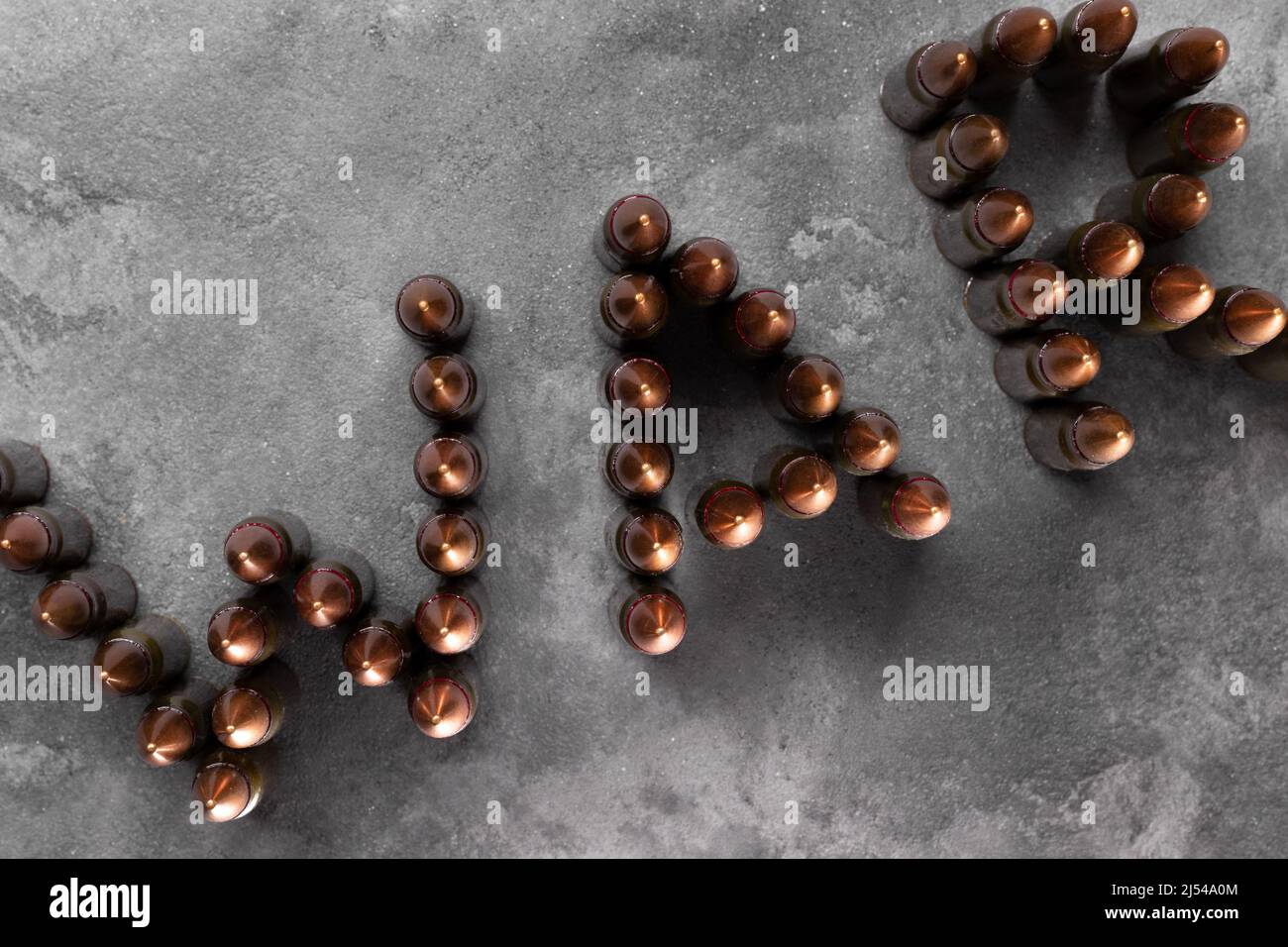 The word War from bullets on gray background. Cartridges 7.62 caliber ...