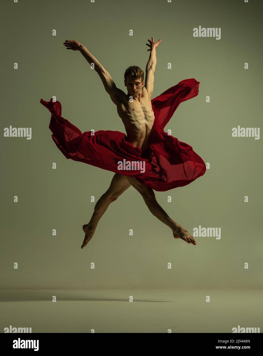 Flight. One young muscled man, flexible ballet dancer in action with ...