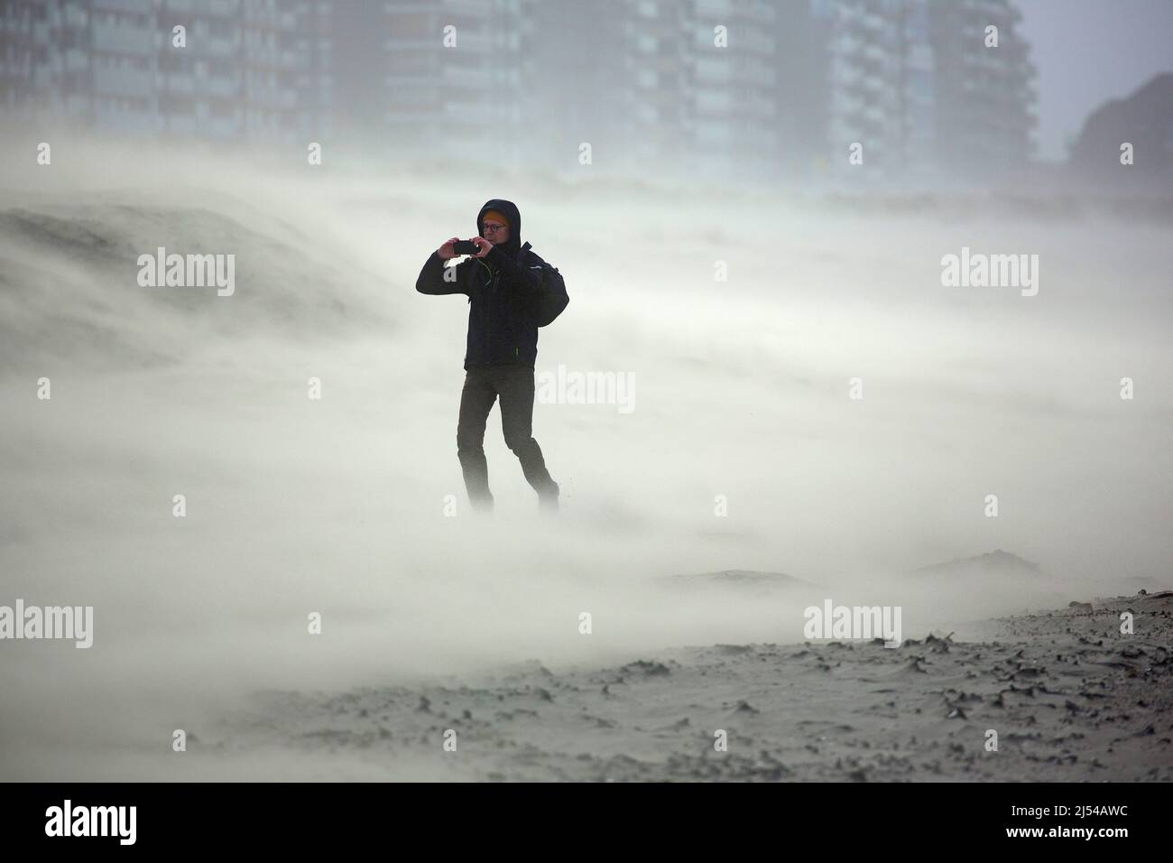 man in the storm on the sandy beach, Hurricane Eunice, Zeynep, 02/18 ...