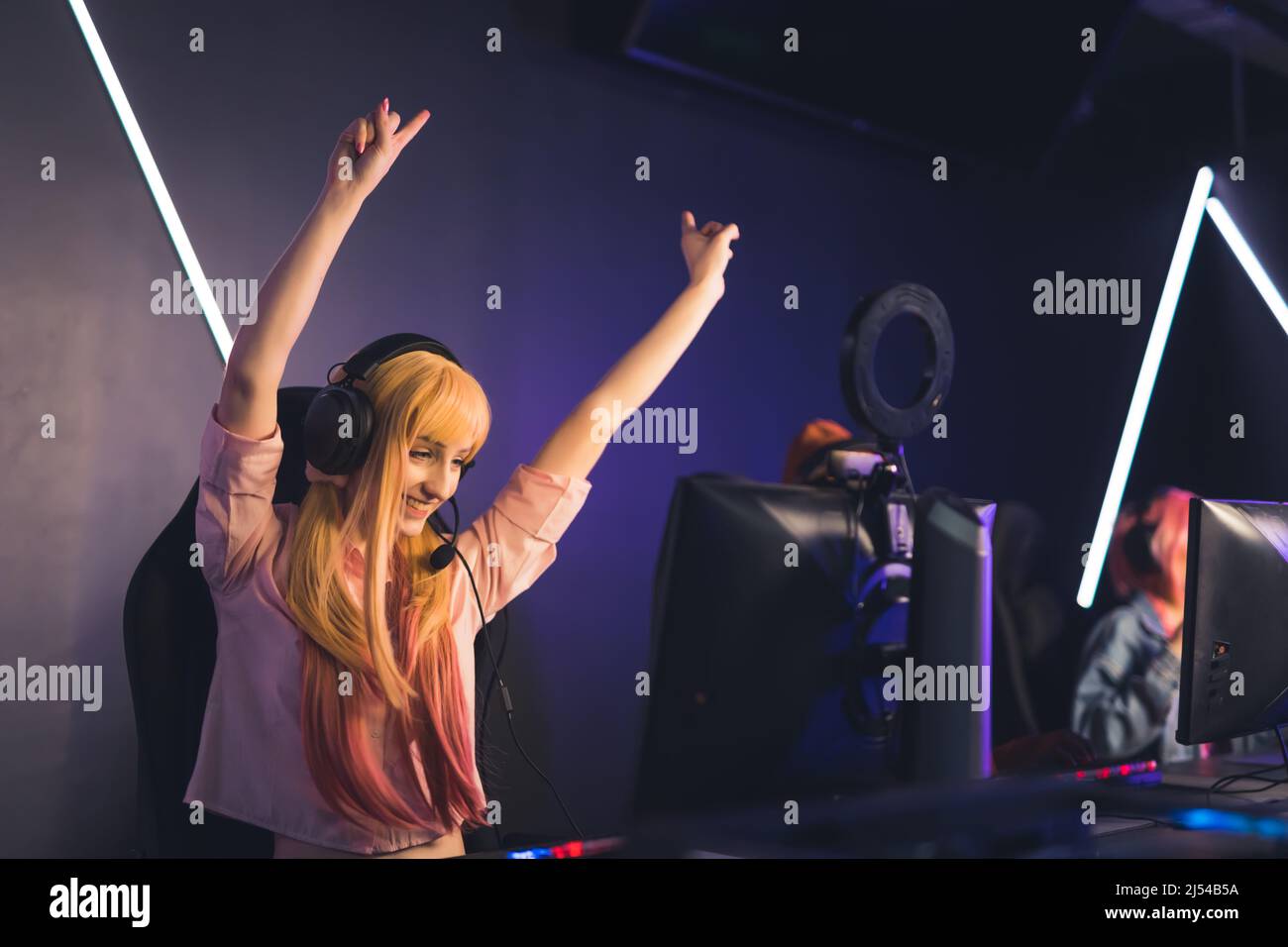 Victory. Excited satisfied long-haired female gamer influencer wins her ...