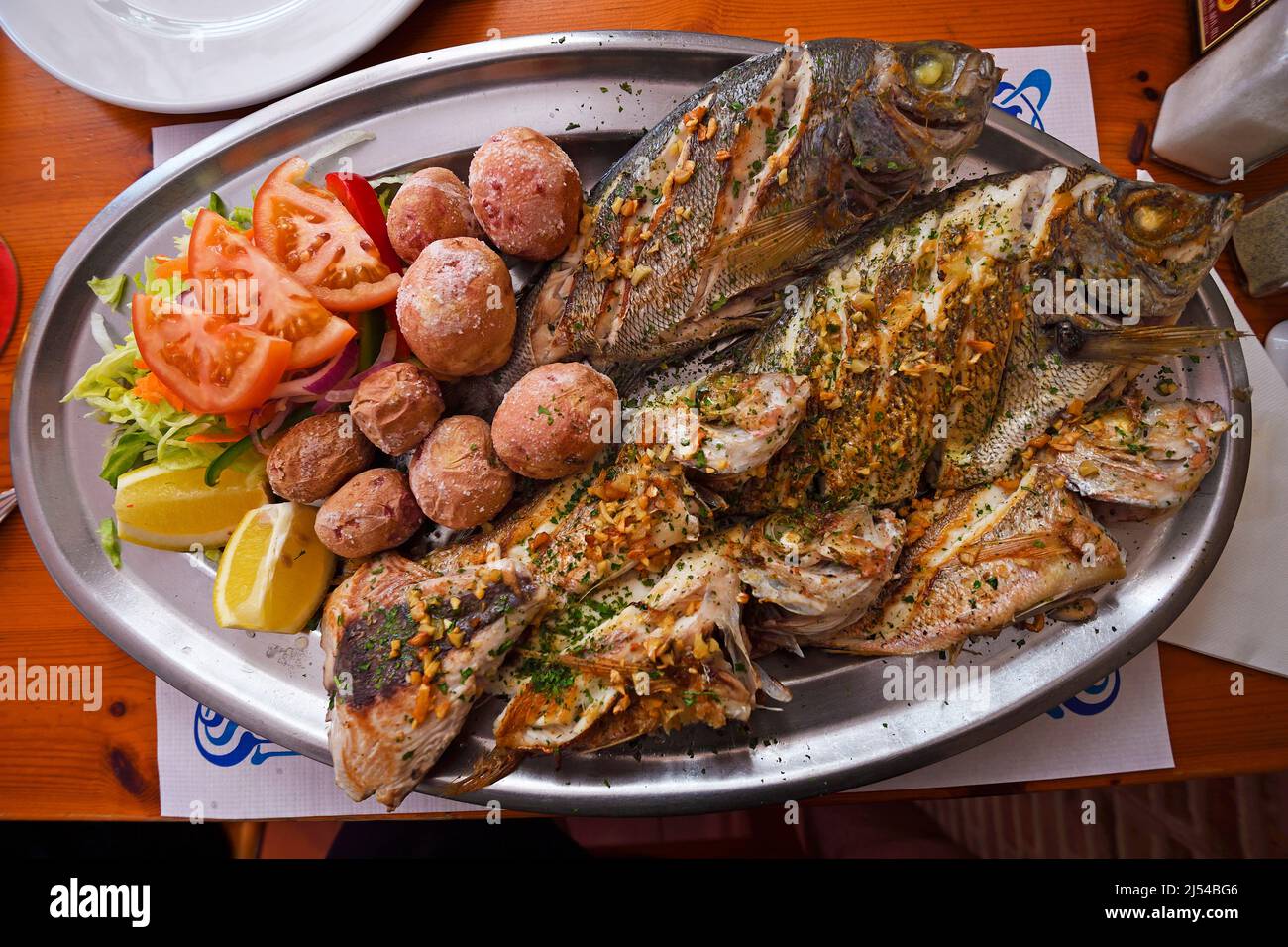 Typical Canarian fish plate with potatoes, different grilled fishes and ...