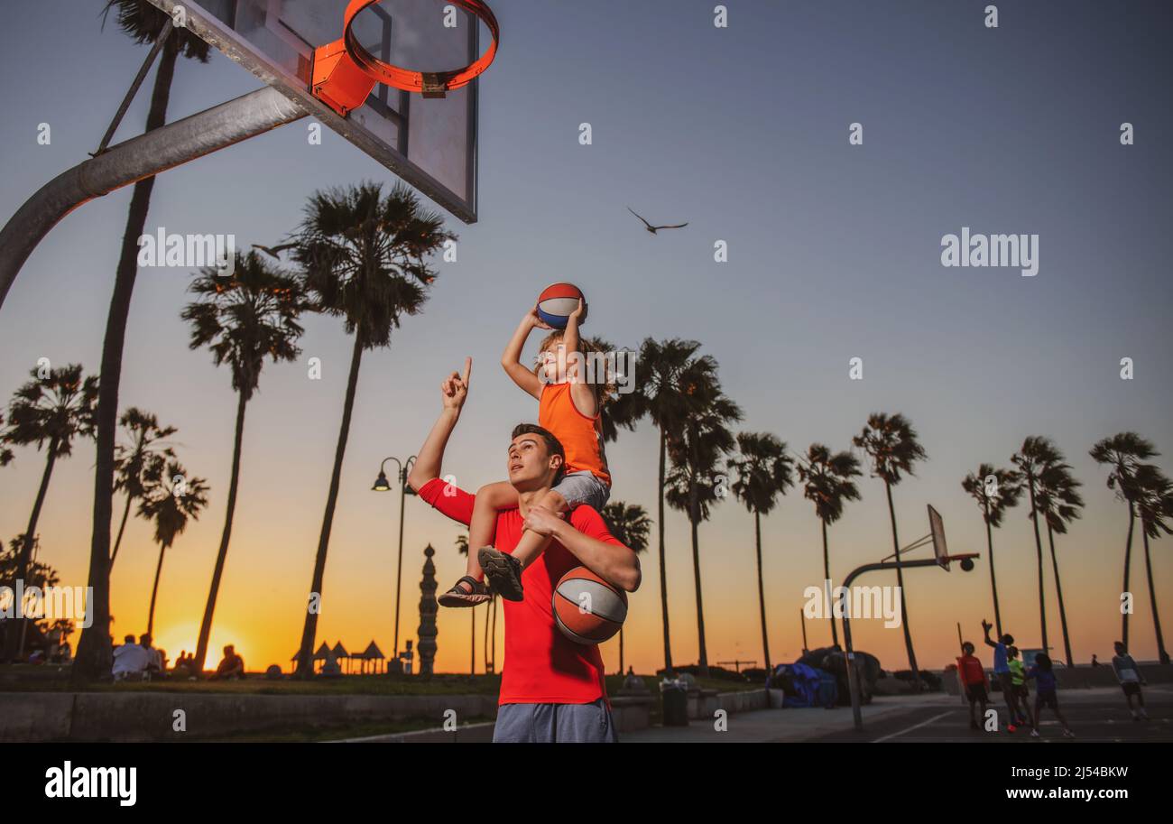 Funny team training basketball, boy with coach. Trainer holding kid boy ...