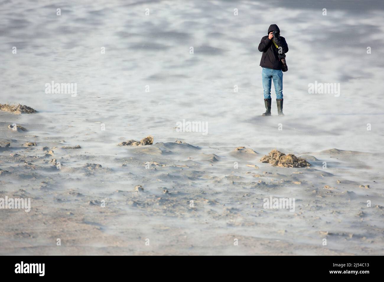 man in the storm on the sandy beach, Hurricane Eunice, Zeynep, 02/18 ...