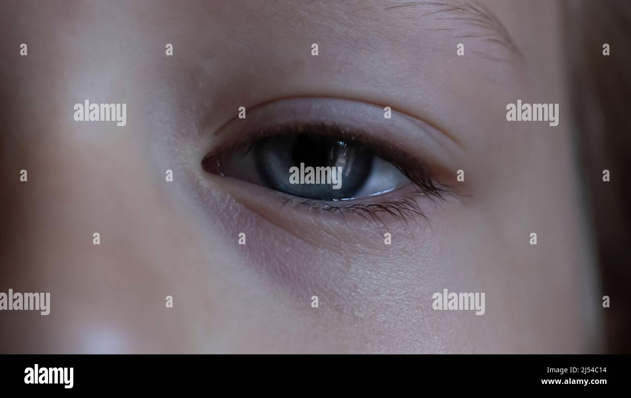 Beautiful eye of a child girl without makeup close-up. Blue pupil with ...