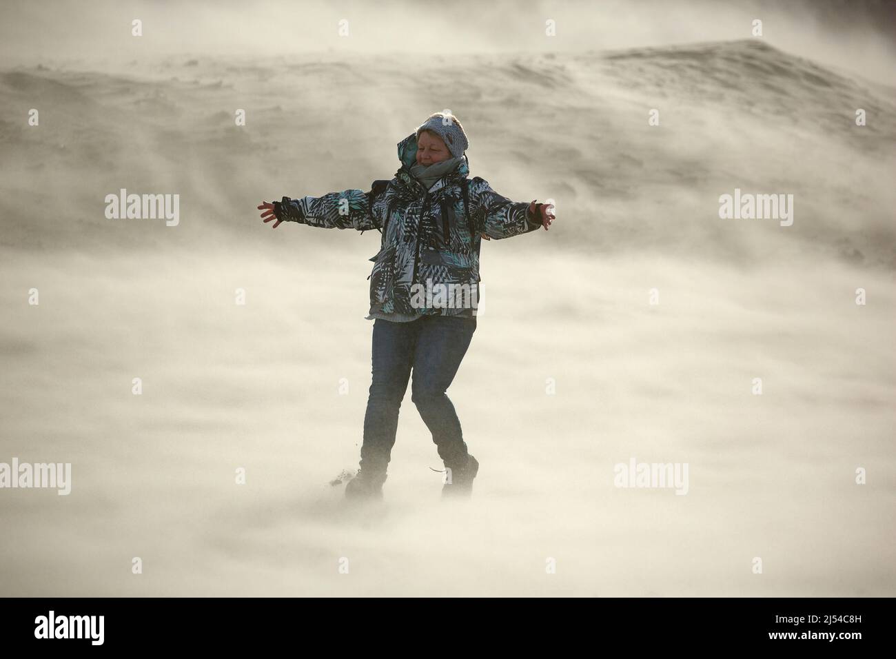 woman in the storm on the sandy beach, Hurricane Eunice, Zeynep, 02/18 ...