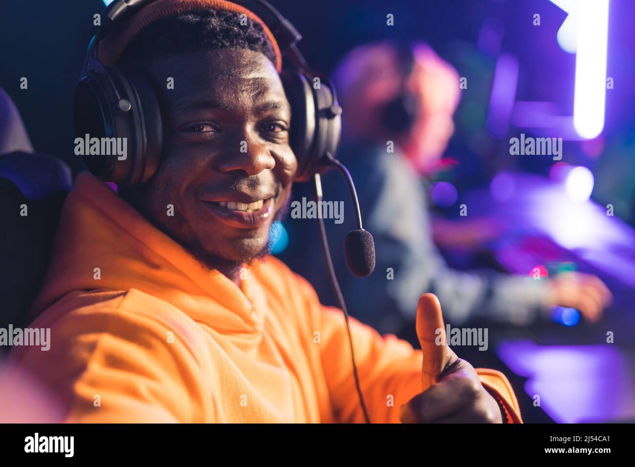 Smiling cheerful African-American male gamer with professional ...