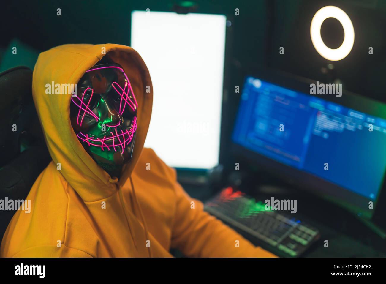 Anonymous internet identity concept. Person in a yellow hoodie in front ...