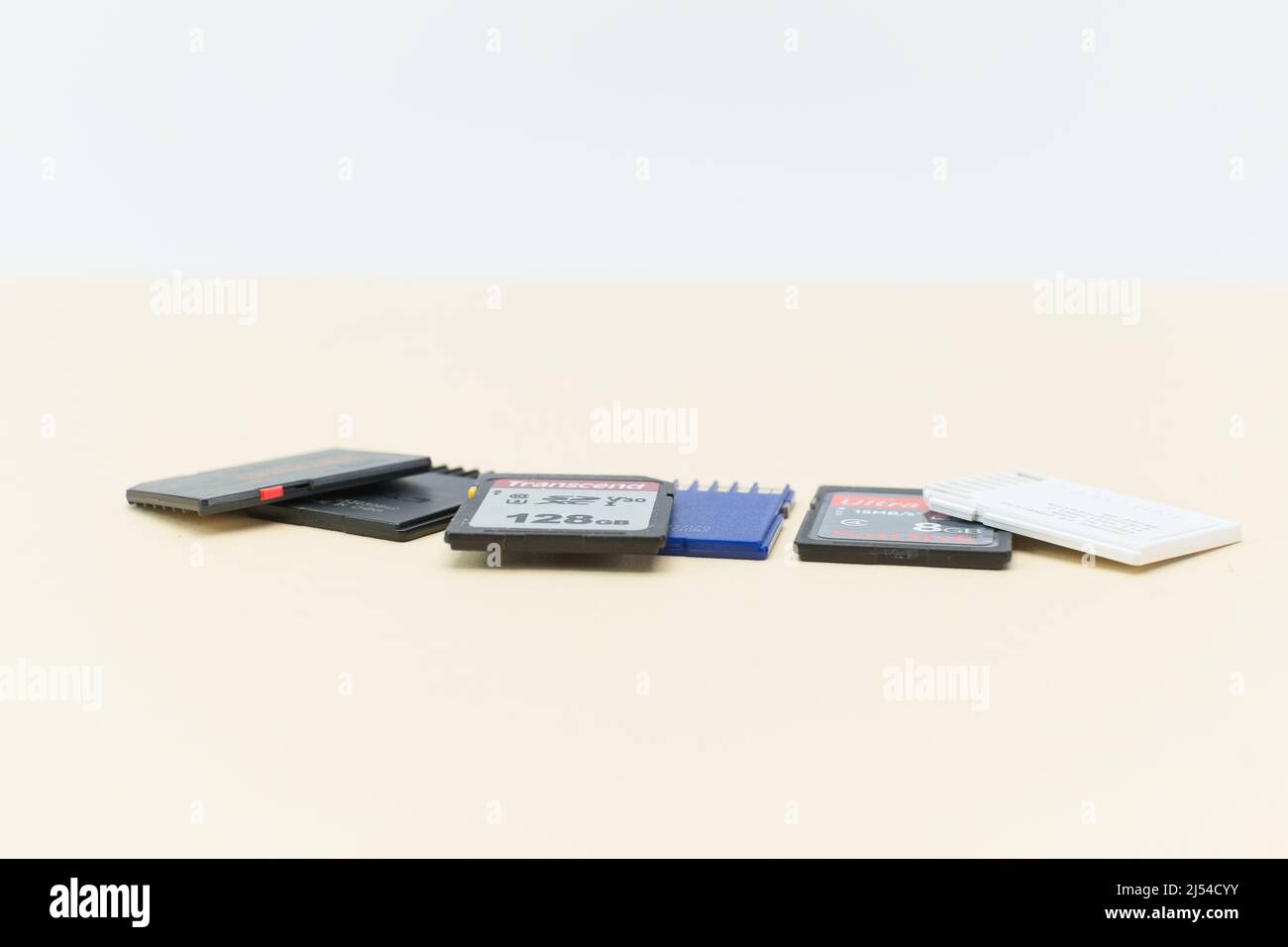 SD format flash memory cards on a beige table with space for text ...