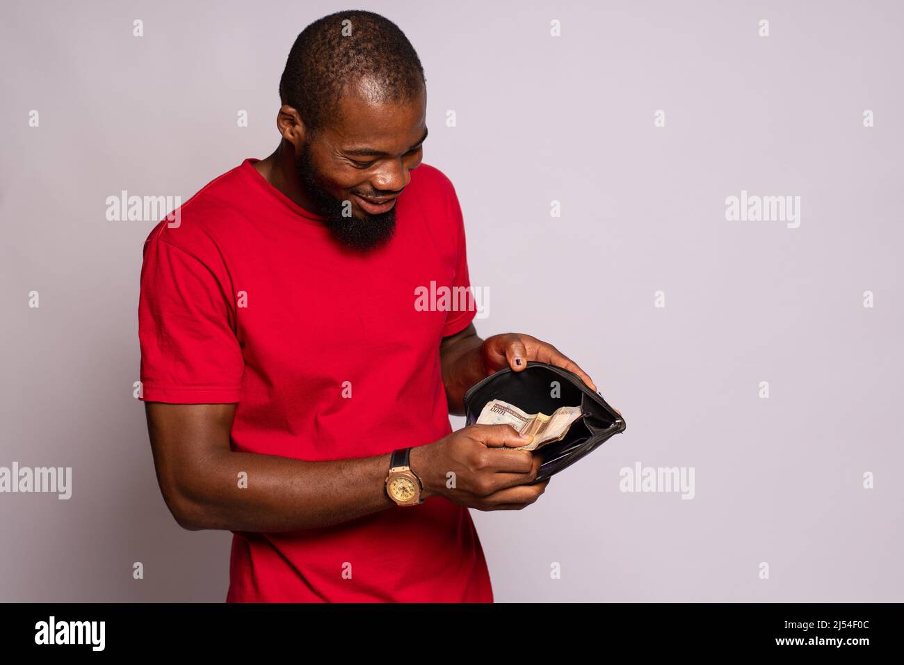 african man taking money from a wallet Stock Photo - Alamy