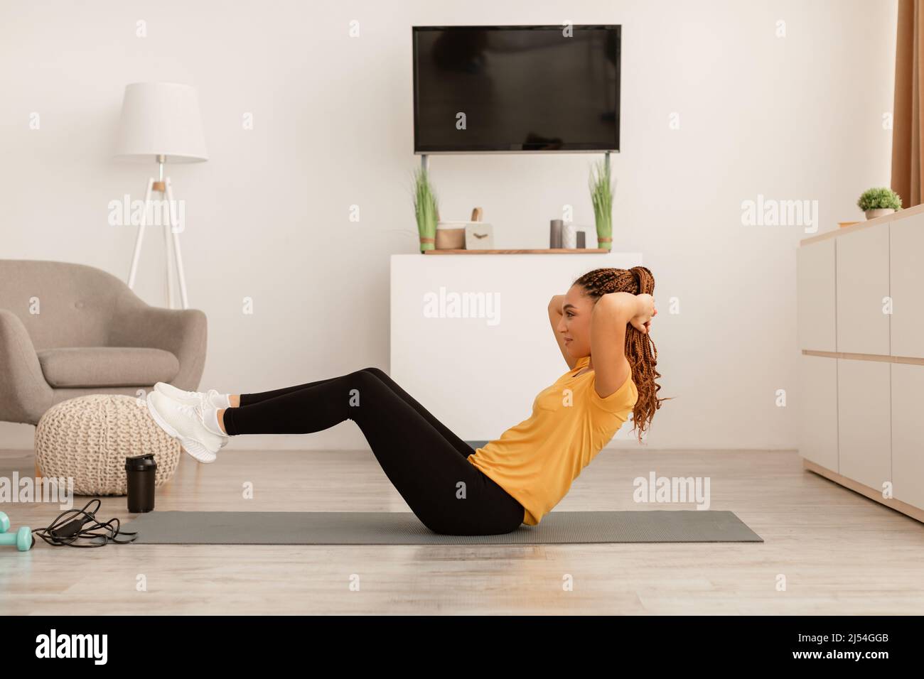 Side View Of Woman Exercising Doing Abs Crunches At Home Stock Photo ...