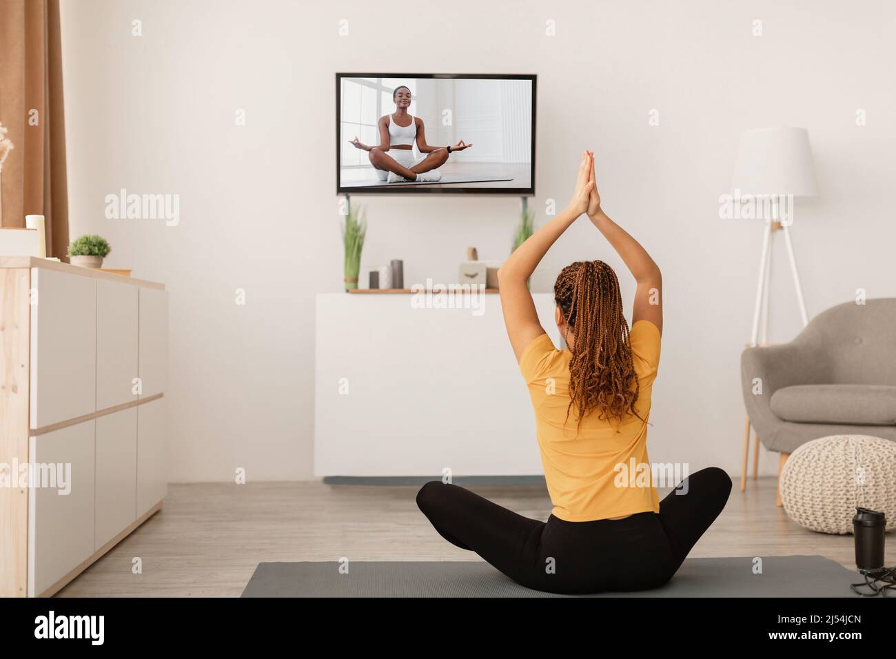 Woman watching video doing yoga hi-res stock photography and images - Alamy