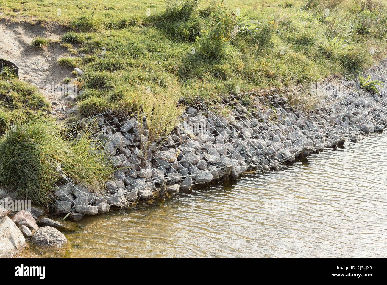 Large granite stones on the river bank. The edge of the river bank ...