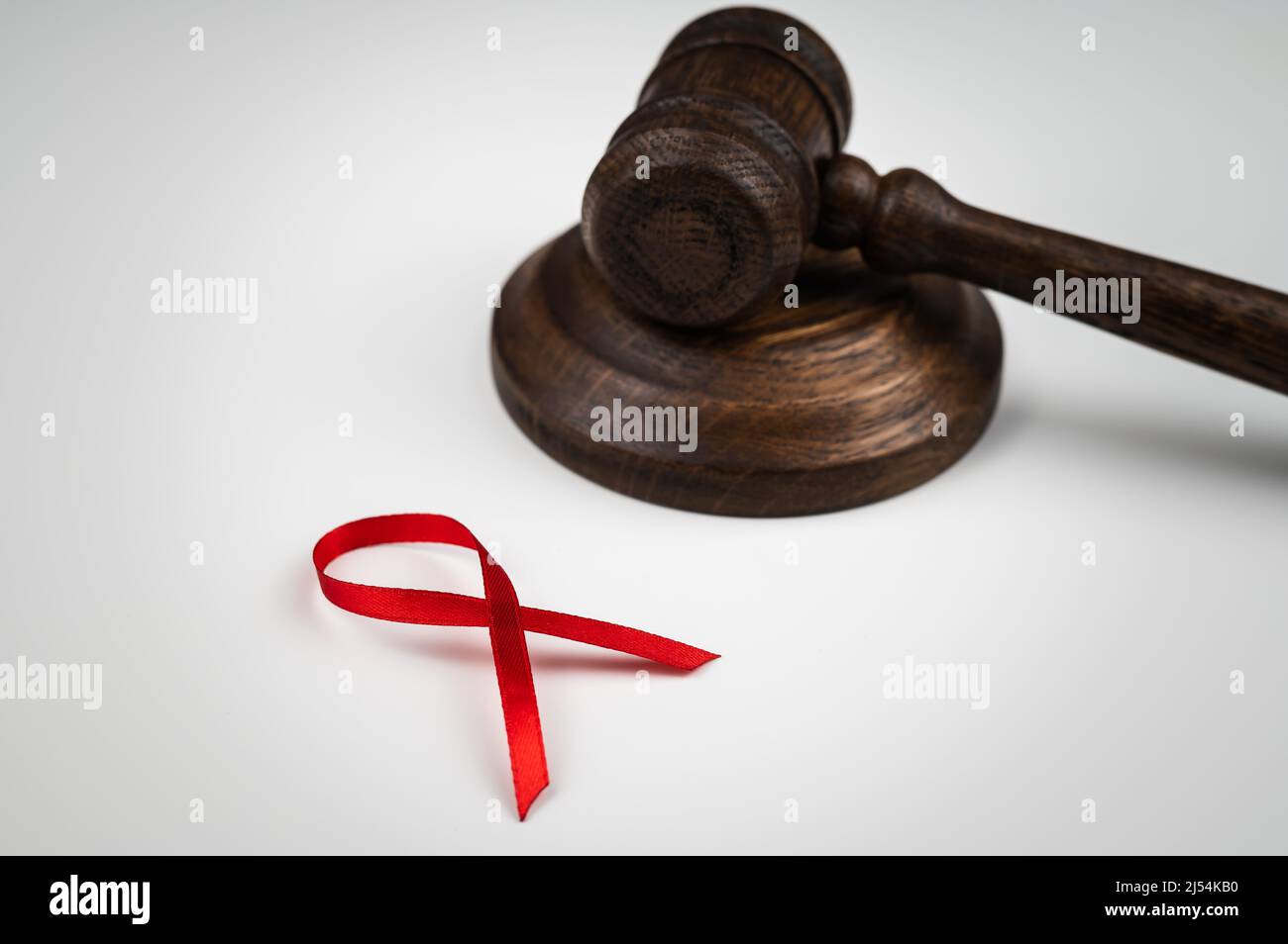 Judicial gavel and red ribbon on a white background. Symbol of the ...