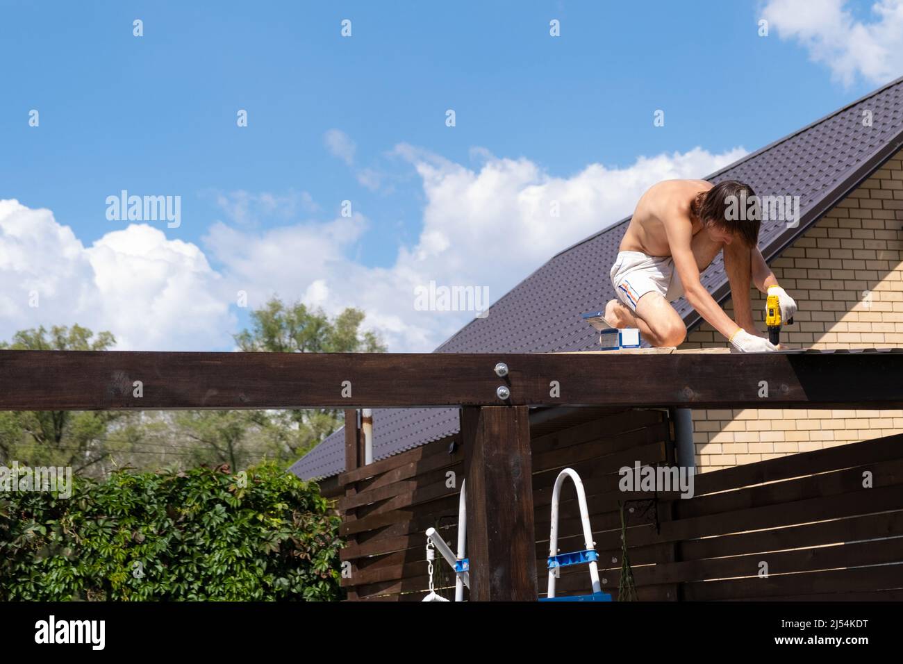 Building roof. Young men repair roof. Roof construction. Working at ...