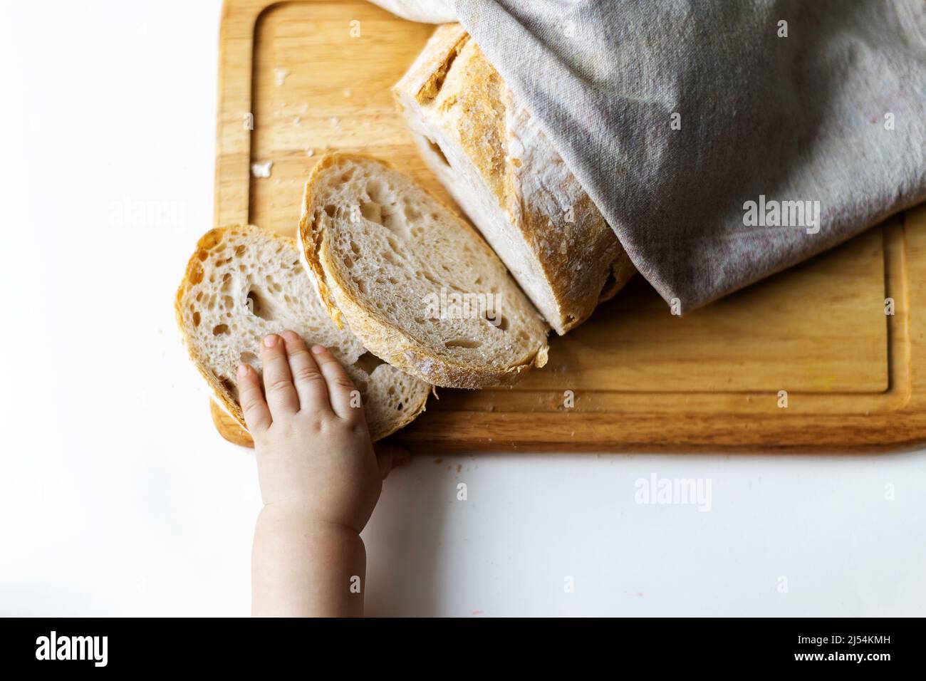 Close up of child's hand picks up a piece of bread Stock Photo - Alamy