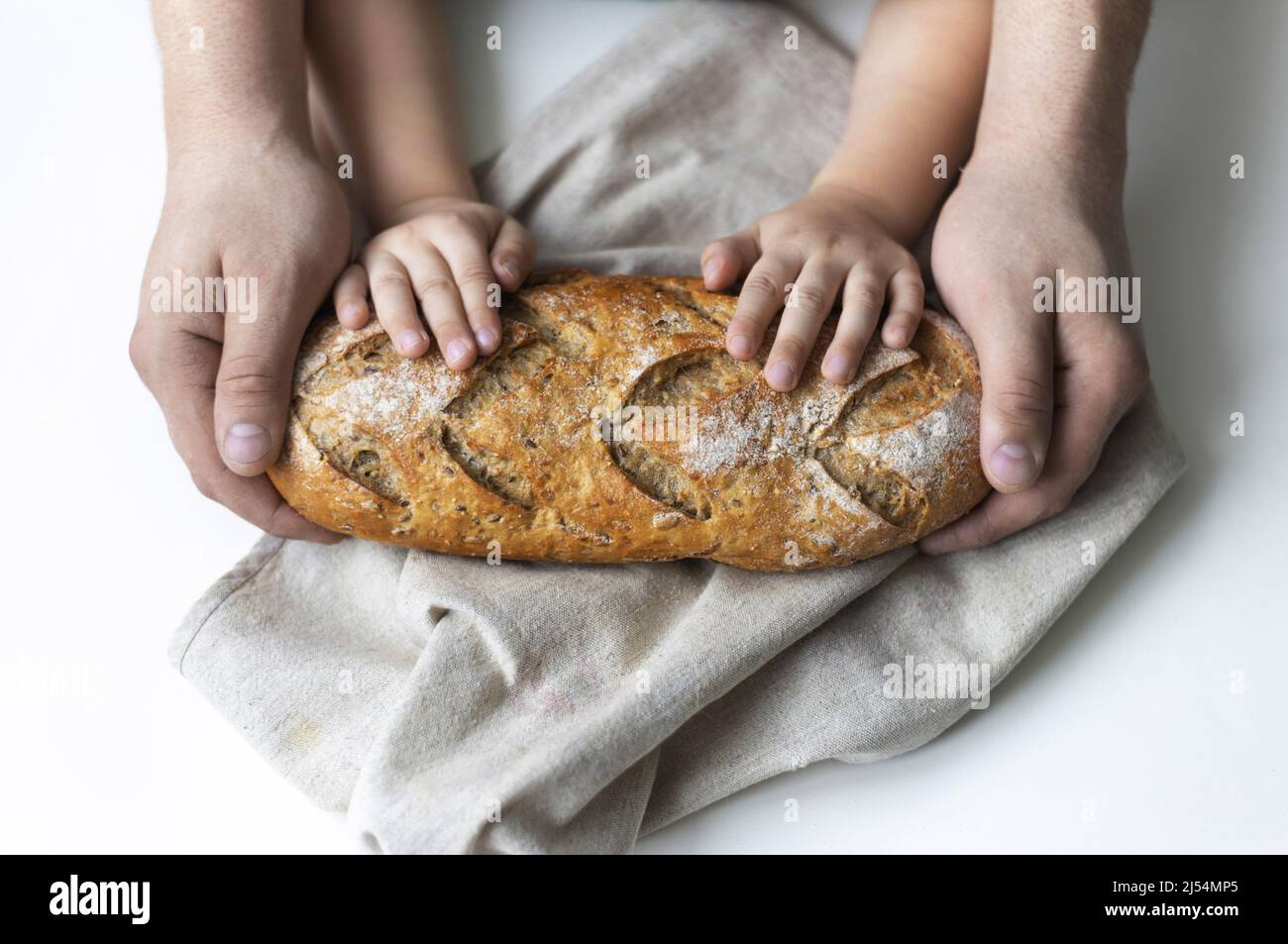 View of bread in the hands of father and son Stock Photo - Alamy